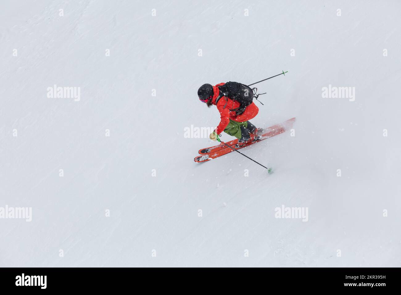 top view of freerider skier making a carving turn on a steep snowy ...