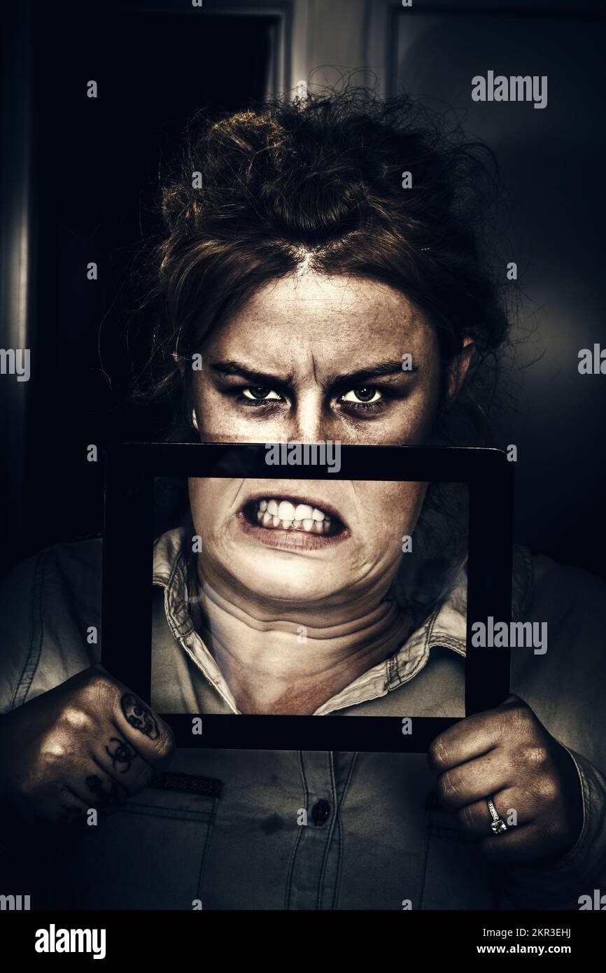 Funny technology portrait of a caucasian woman snarling on the screen ...