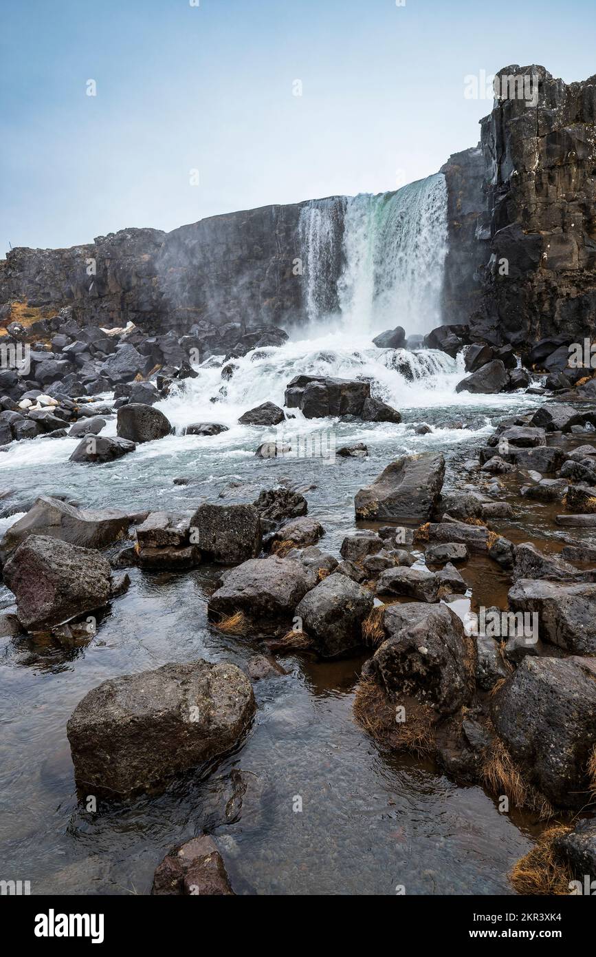Öxarárfoss waterfall in late winter. The beautiful waterfall flows from ...