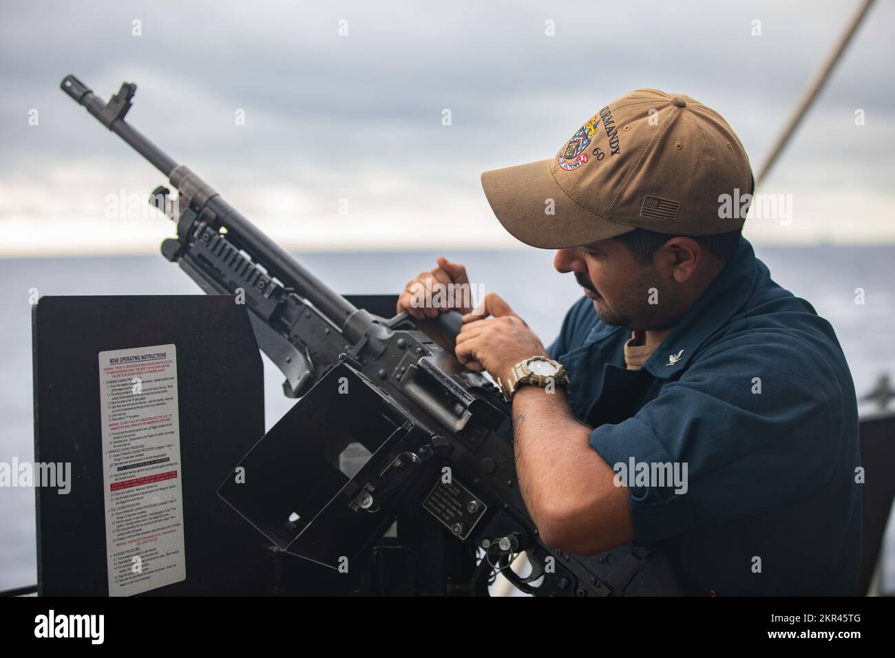 Gunner’s Mate 3rd Class Marcelo Hernandez cleans and reattaches the ...