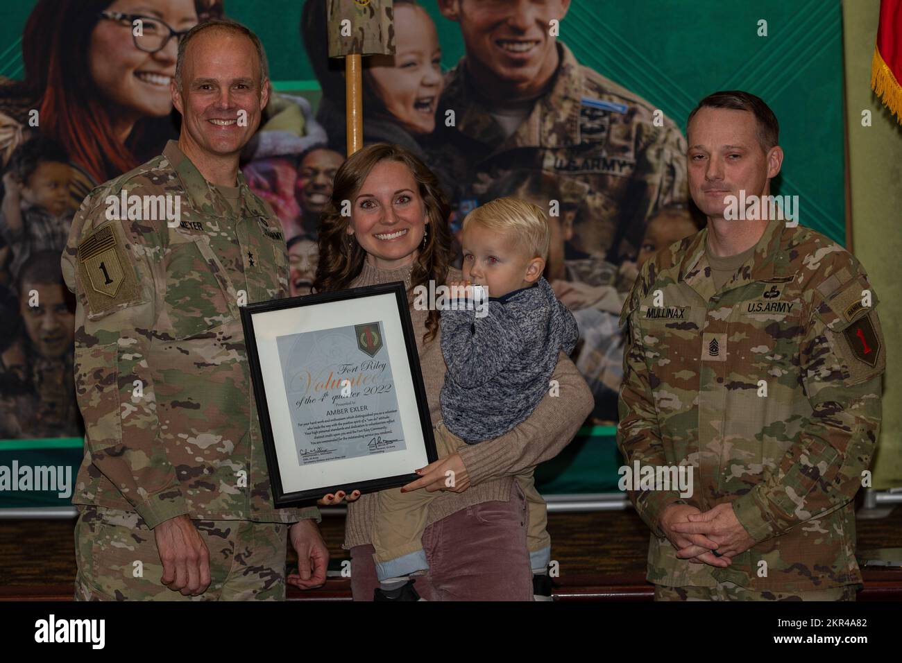 Amber Exler (middle) receives a Volunteer of the Quarter Award from Maj ...