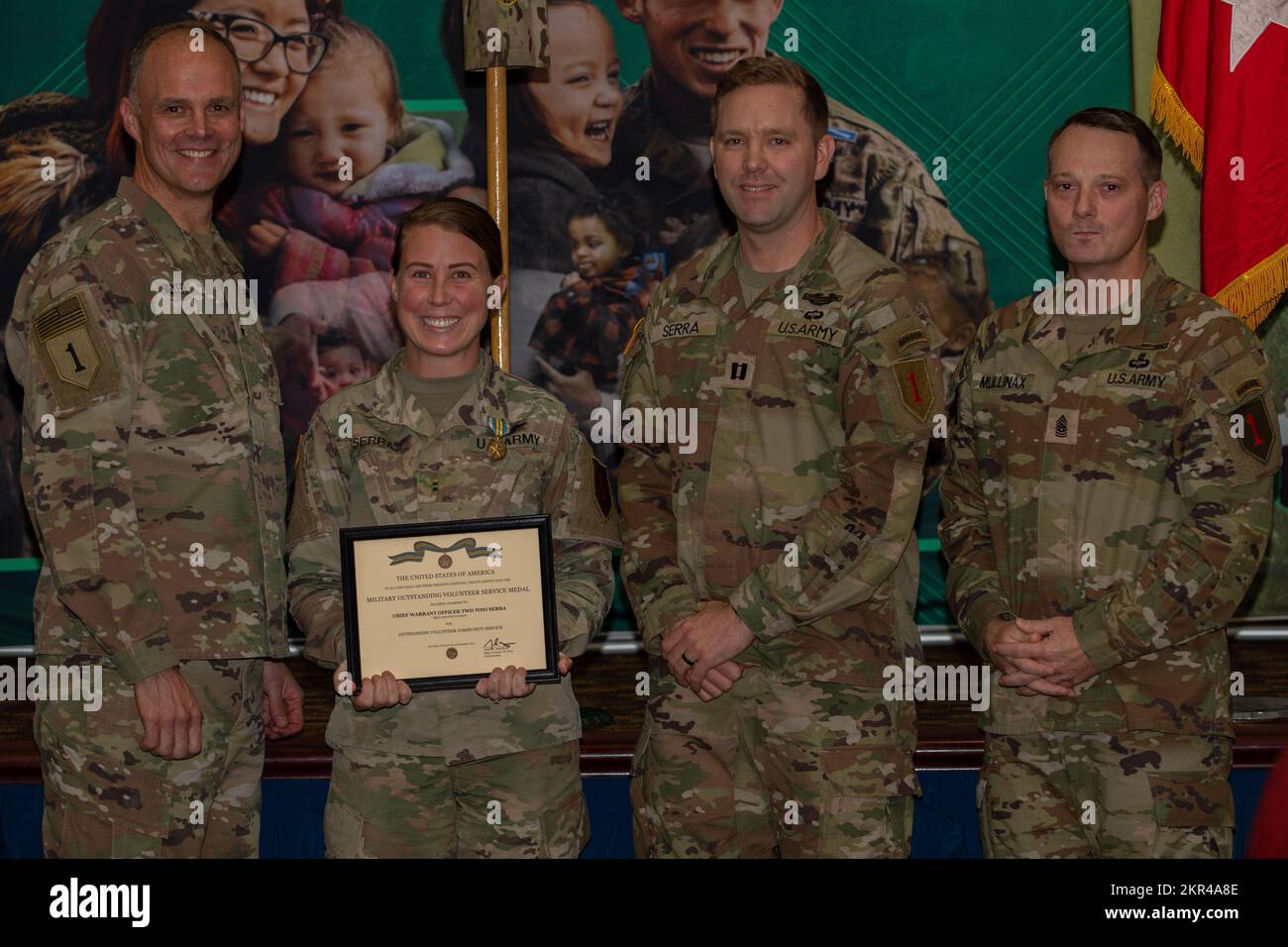U.S. Army Chief Warrant Officer 2 Toni Serra (middle left) receivies a ...