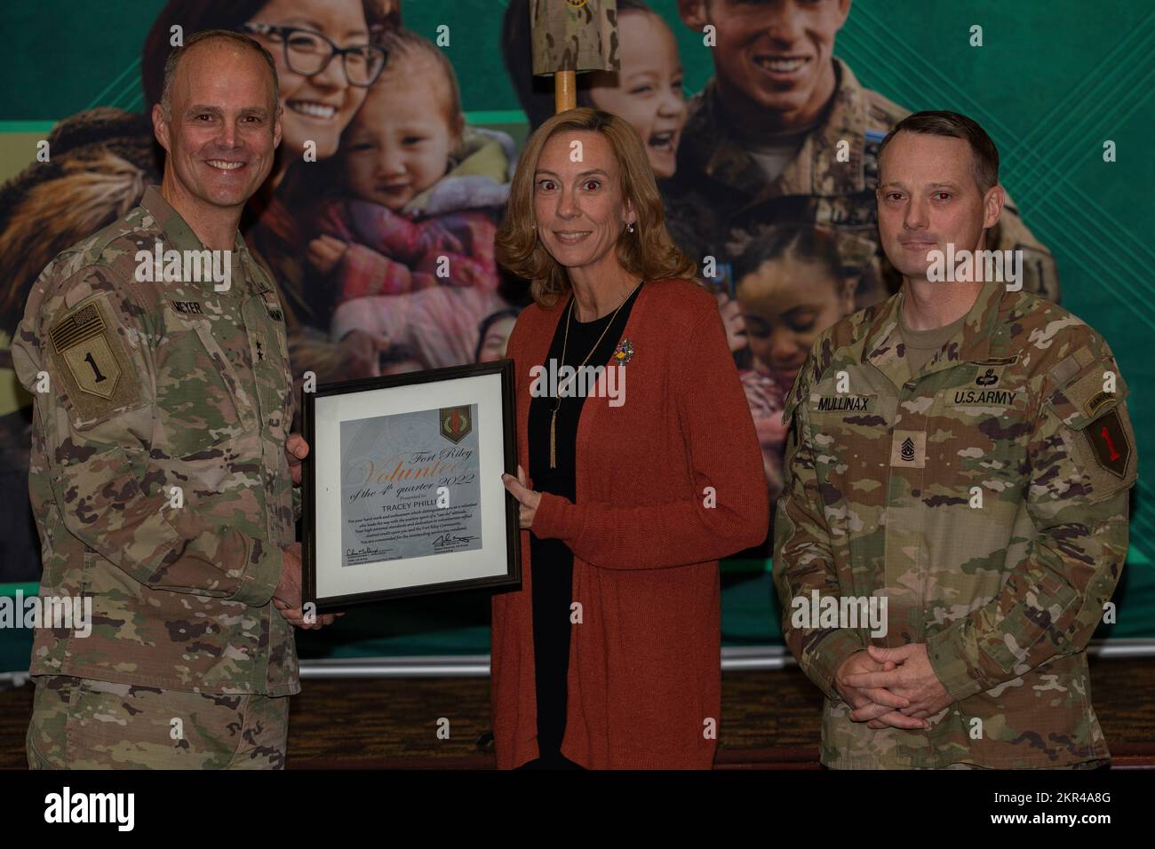 Tracey Phillips (middle) receives a Volunteer of the Quarter Award from ...