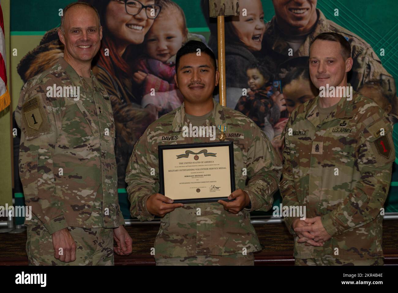 U.S. Army Sgt. Michael Davies (middle), receives a Military Outstanding ...