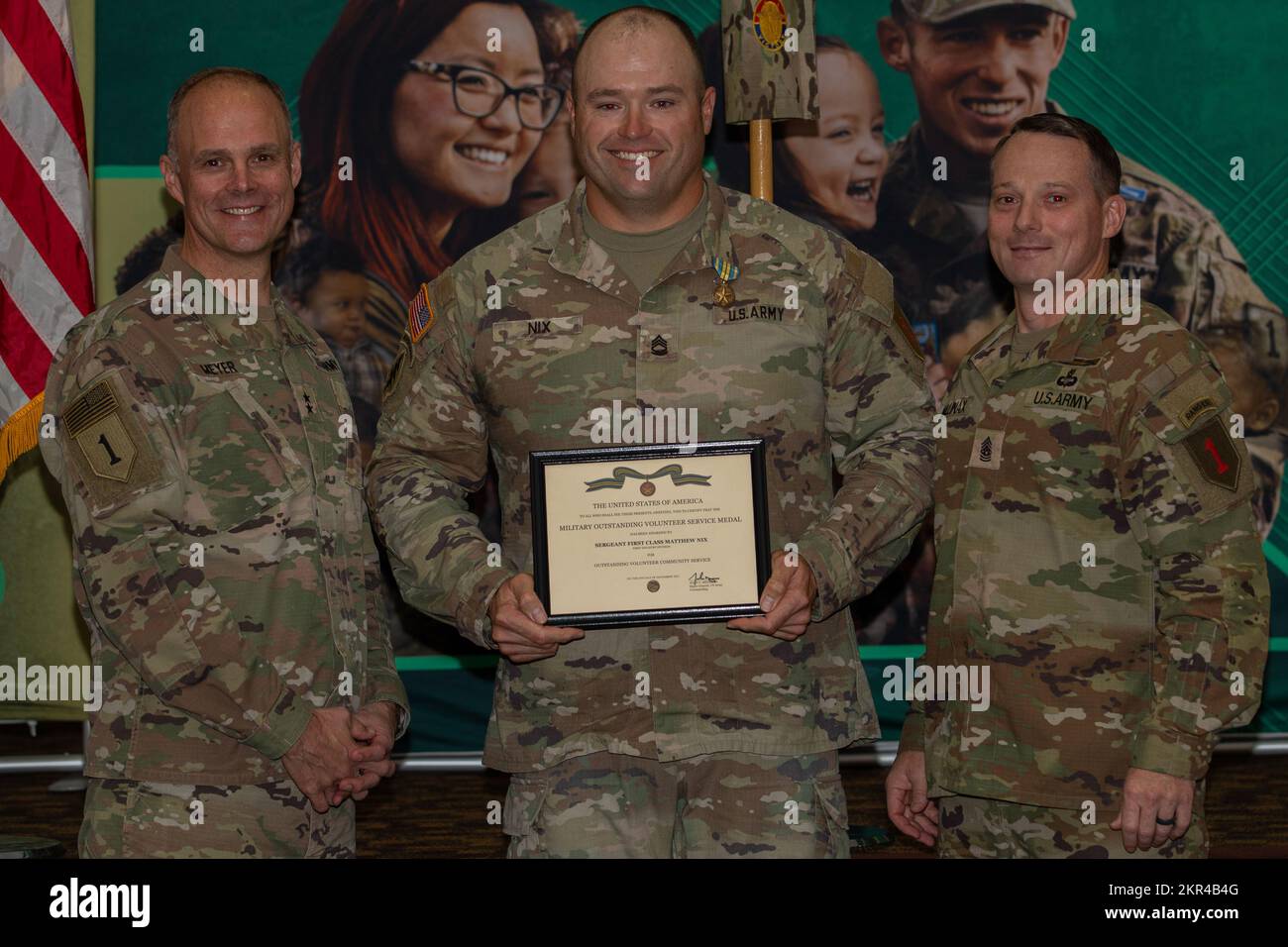 U.S. Army Sgt. 1st Class Matthew Nix (middle), receives a Military ...