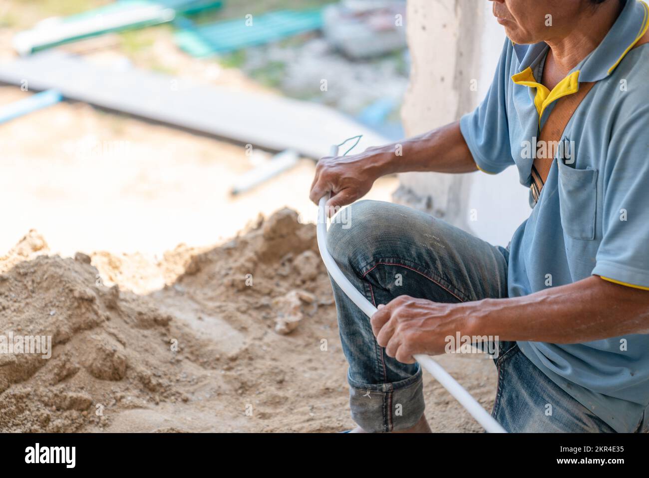 Techincian use knee bend electric wire pipe spring inside for curve in ...