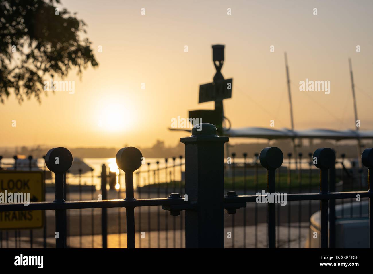 Downtown waterfront sunrise golden glow back-lights in silhouette ...