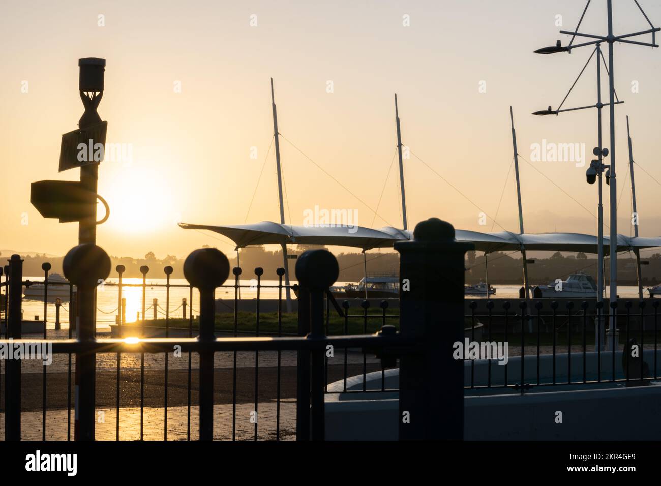 Downtown waterfront sunrise golden glow back-lights in silhouette ...