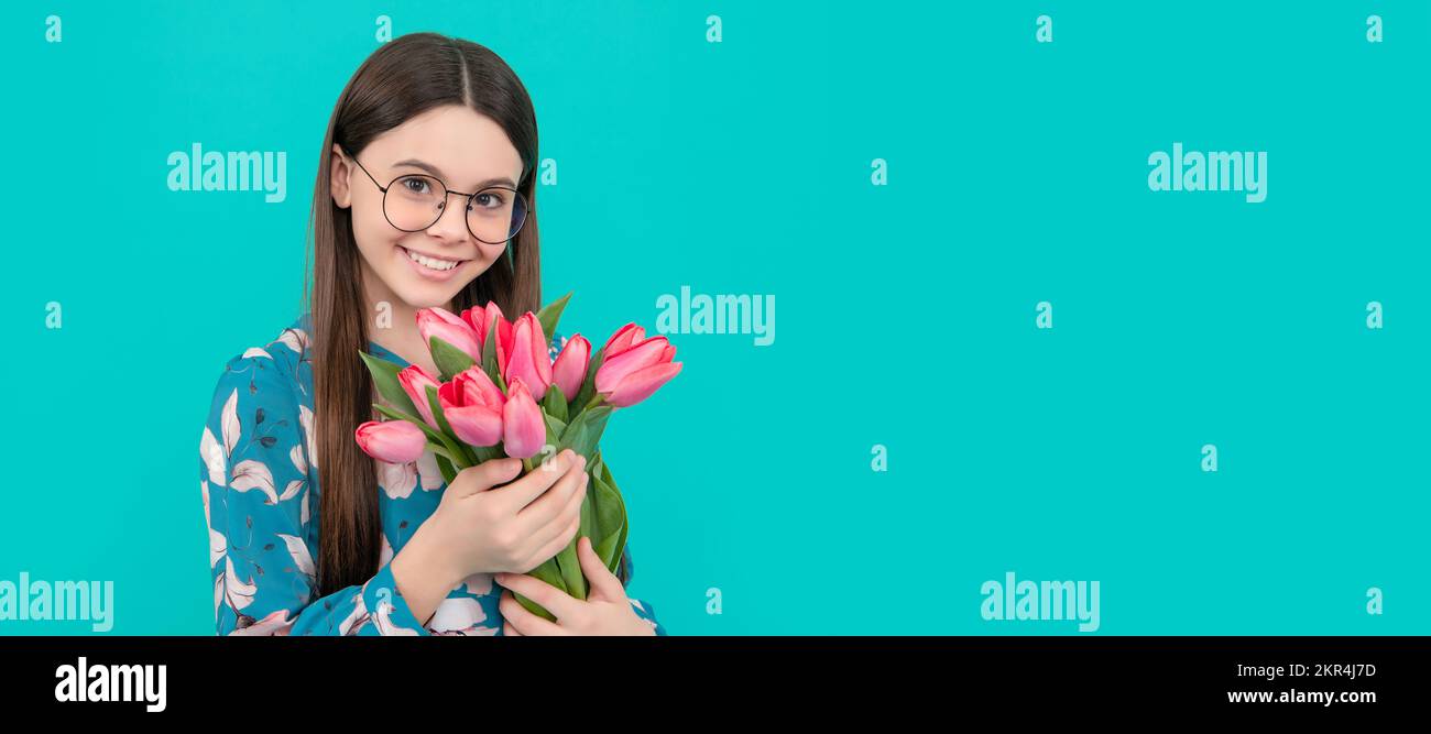 kid hold flowers for 8 of march. teen girl with spring bouquet on blue ...
