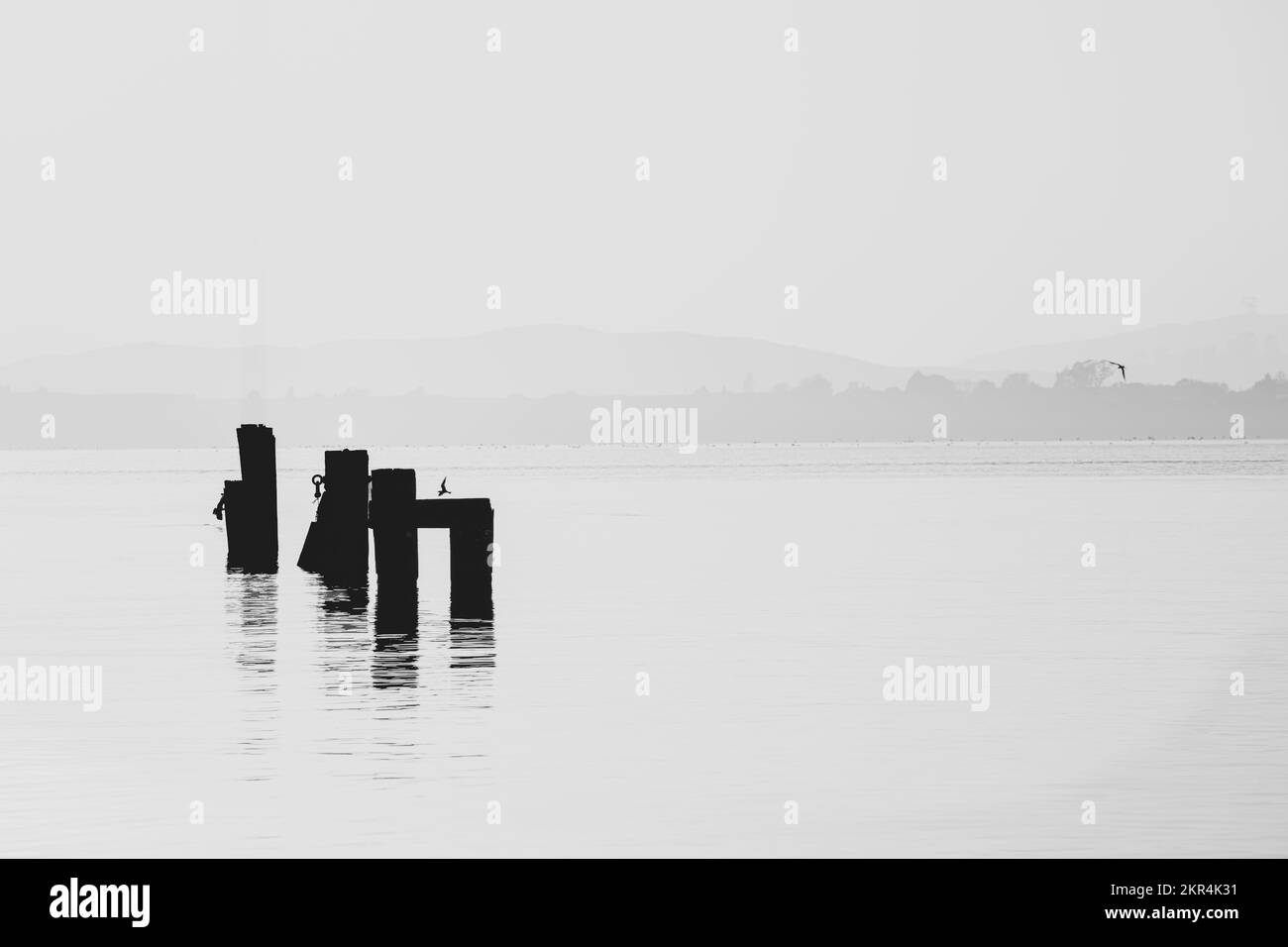 Old harbour structure minimalism at sunrise on calm misty morning Stock ...
