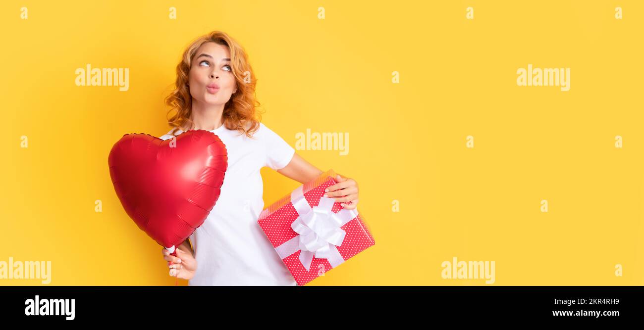 funny redhead woman with red heart balloon and present box. happy ...