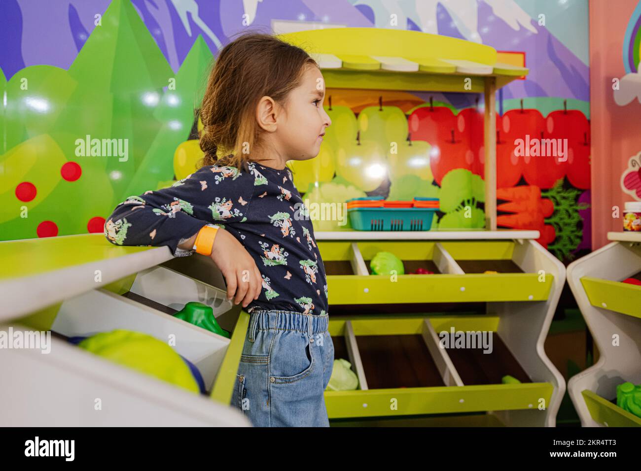 Baby girl playing at indoor kids kitchen playground Stock Photo - Alamy