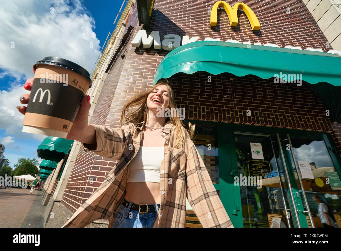 KALININGRAD, RUSSIA - CIRCA JULY, 2022: woman posing with paper cup ...
