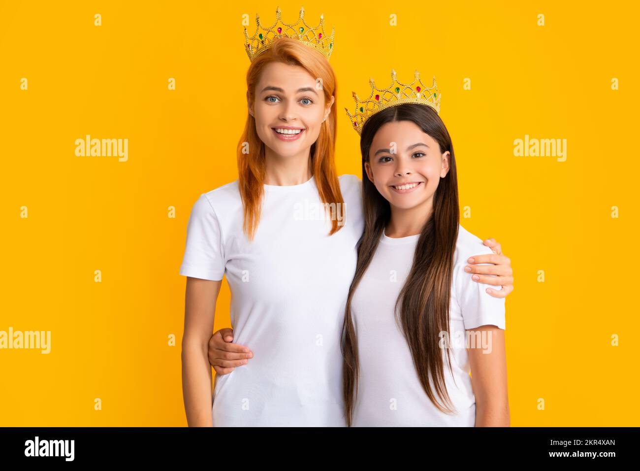 Funny family on a yellow background. Mother and her daughter girl with ...