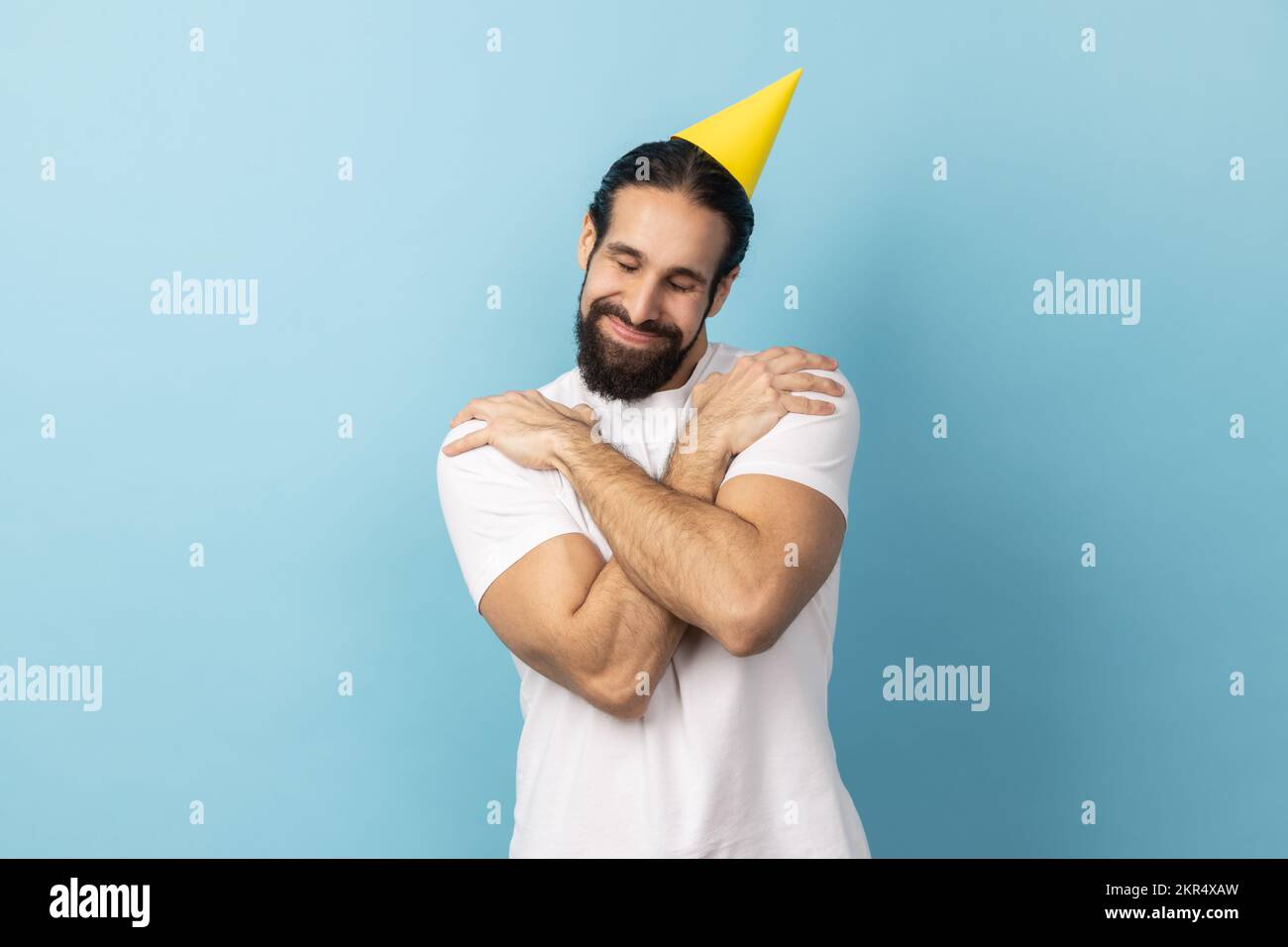 Portrait of smiling handsome birthday man with beard wearing white T ...