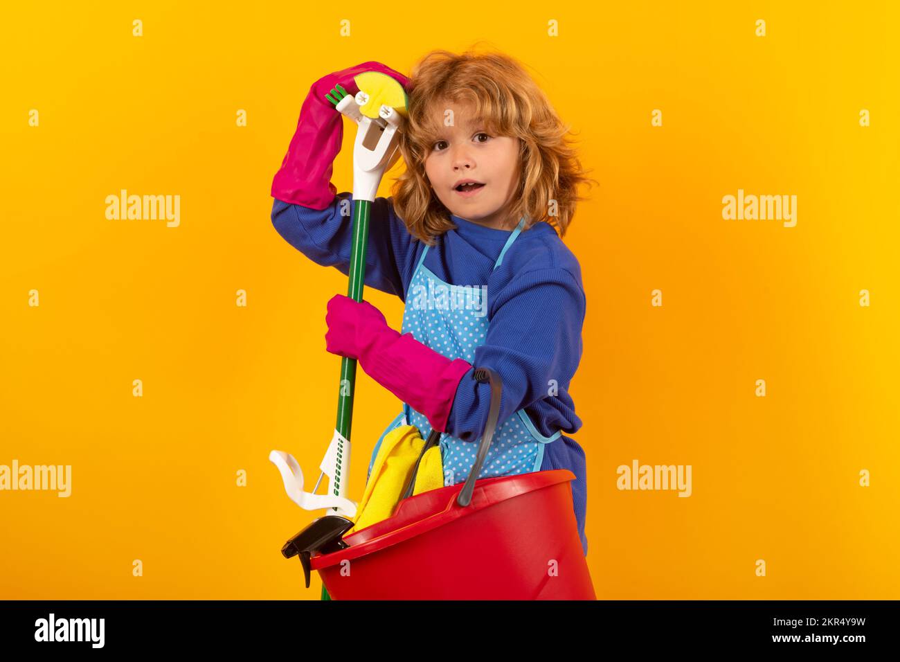 Cleaning house. Studio isolated portrait of child mopping house ...