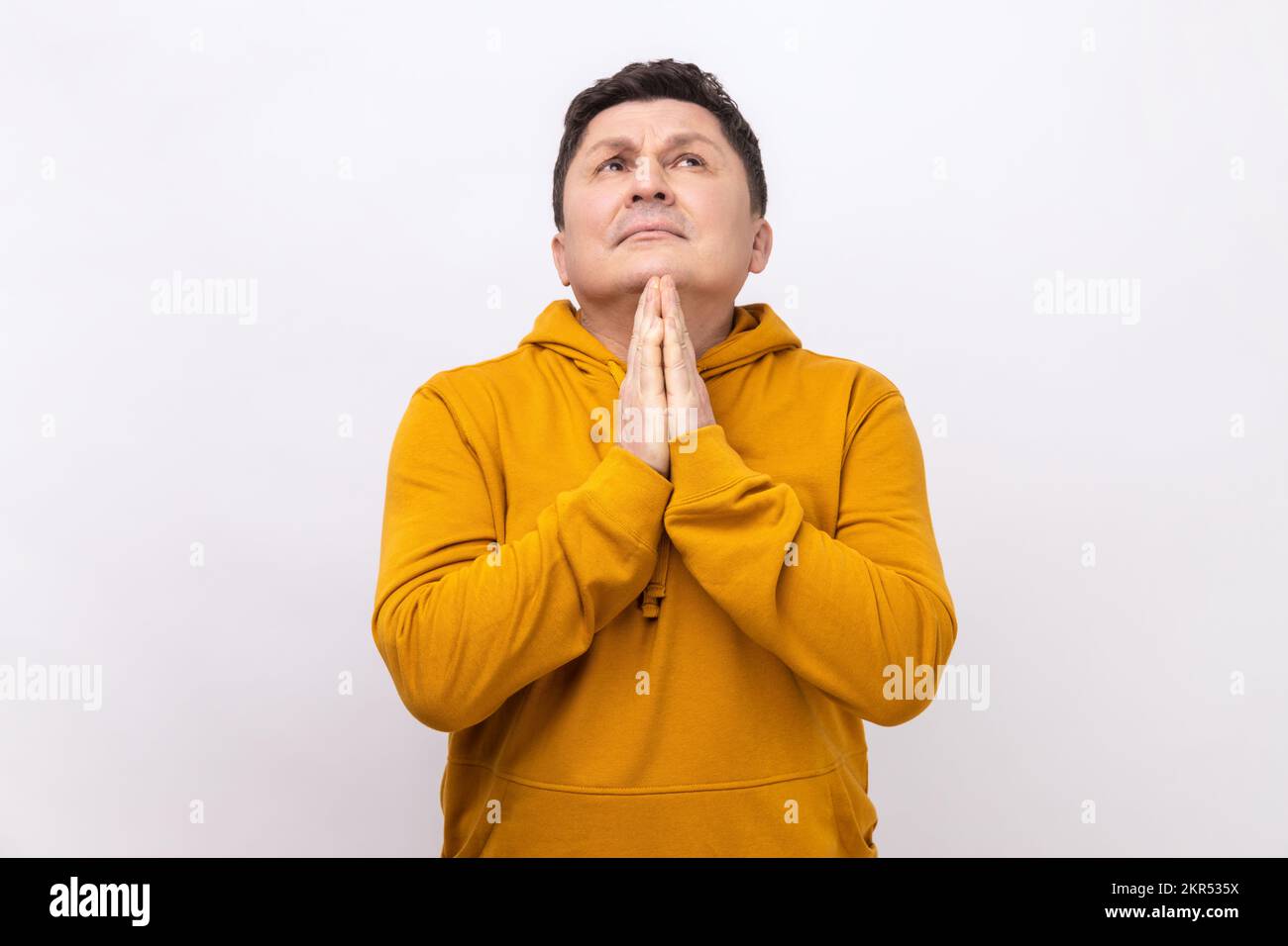 Portrait of handsome middle aged man praying up heartily, feeling ...