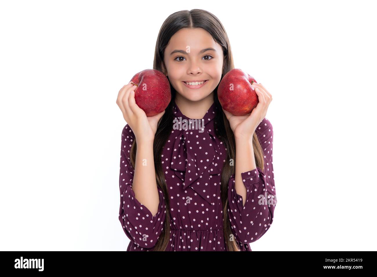 Child girl eating an apple over isolated white studio background ...