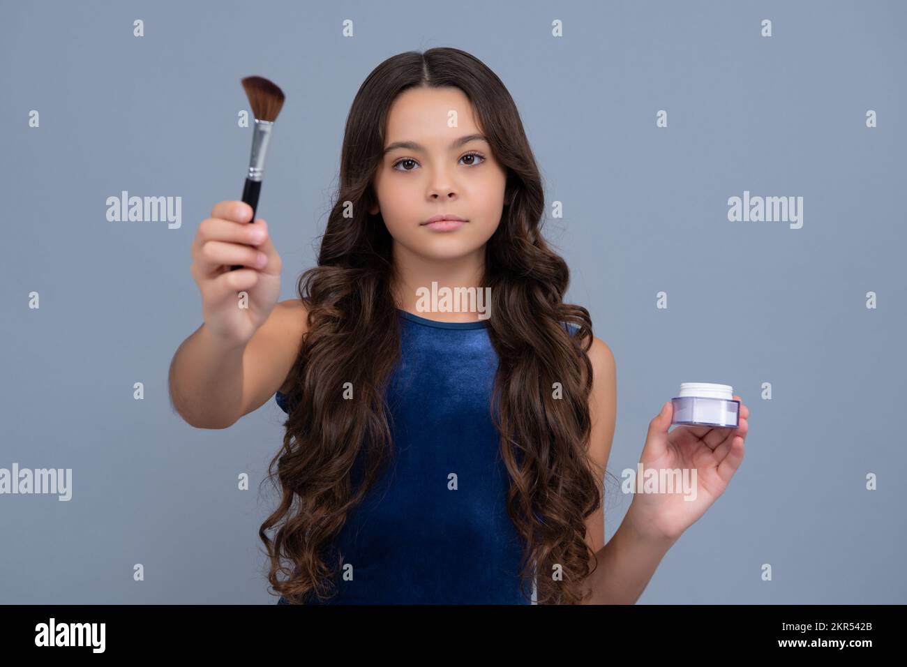 Kids make up products. Makeup teen child artist apply face powder with ...