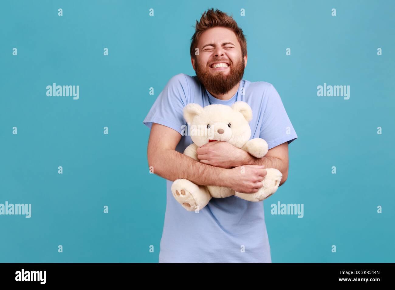 Portrait of satisfied handsome bearded man standing with closed eyes ...