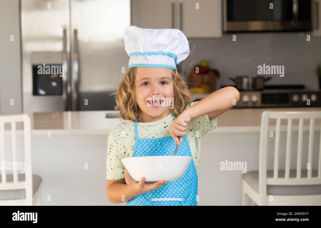 Child chef cook with cooking plate. Fun kids kitchen. Funny little kid ...