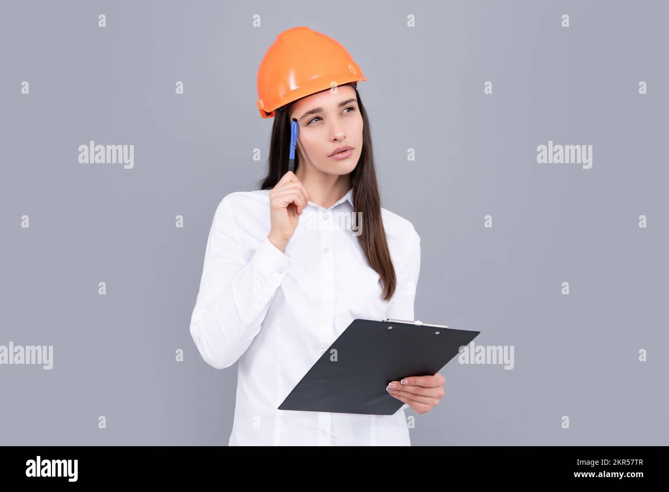 Thinking architect worker, female constructor engineer. Young beautiful ...