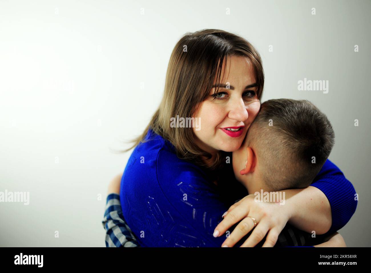 hugs love family comfort Sad child hugging his mother Mom in a blue ...