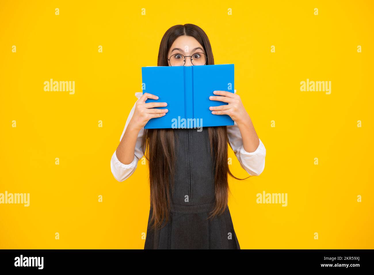 Teen girl pupil hold books, notebooks, isolated on yellow background ...