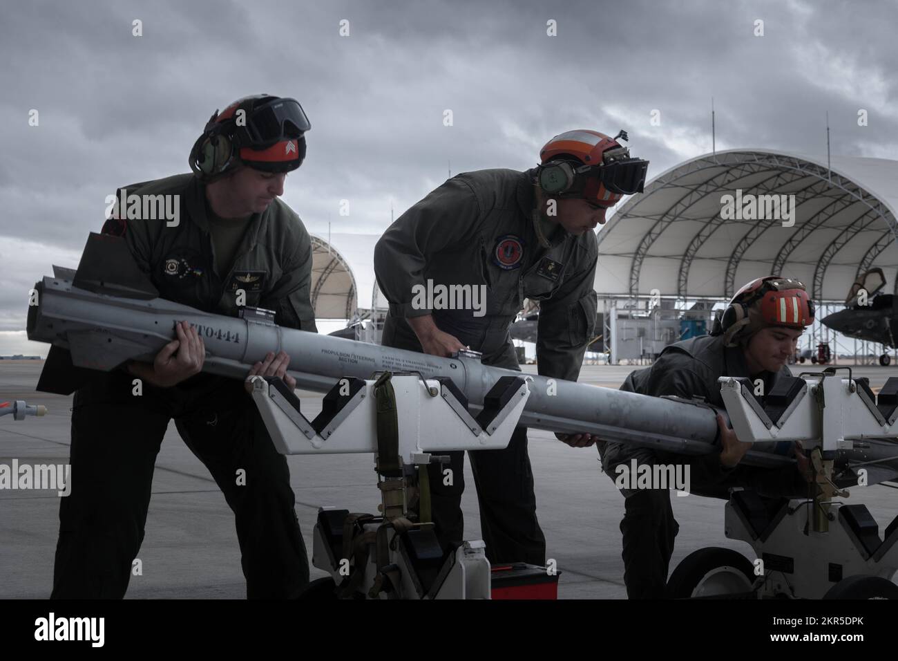 U.S. Marines from across 3rd Marine Aircraft Wing carry an AIM-9 ...