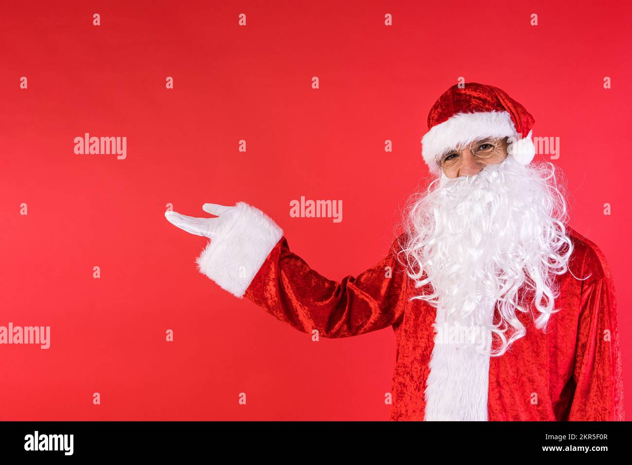 Man dressed as Santa Claus, pointing to the side with his finger, on ...