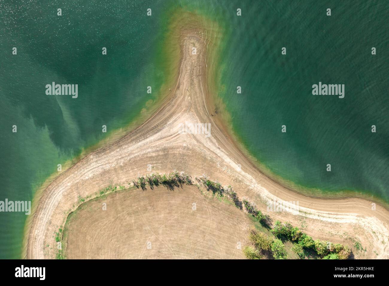 Aerial view of island with green trees surrounded by sea or ocean with ...
