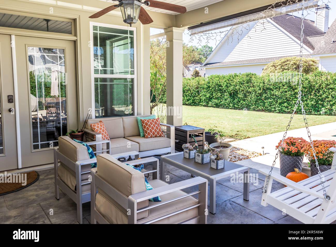 Covered outdoor patio in a new construction house home with guest ...