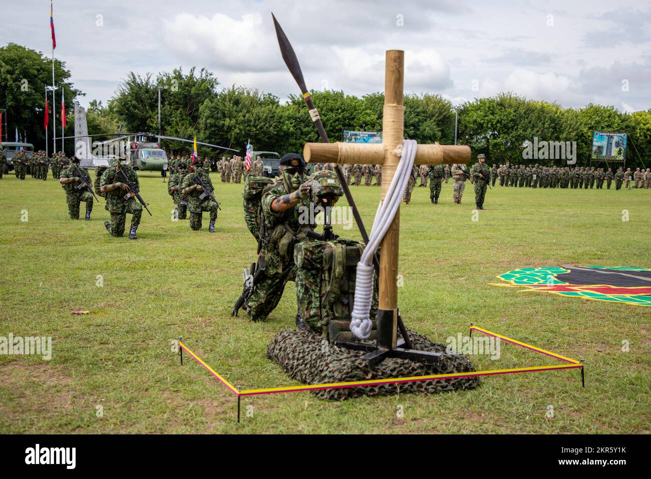 A Colombian Army Soldier places a combat helmet on a fallen Soldier ...