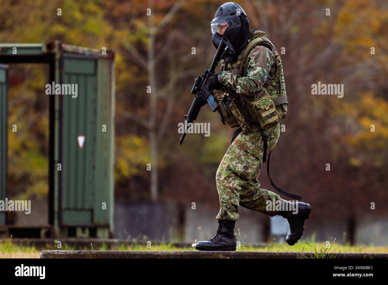 A Japan Ground Self-Defense Force (JGSDF) member runs for cover during ...
