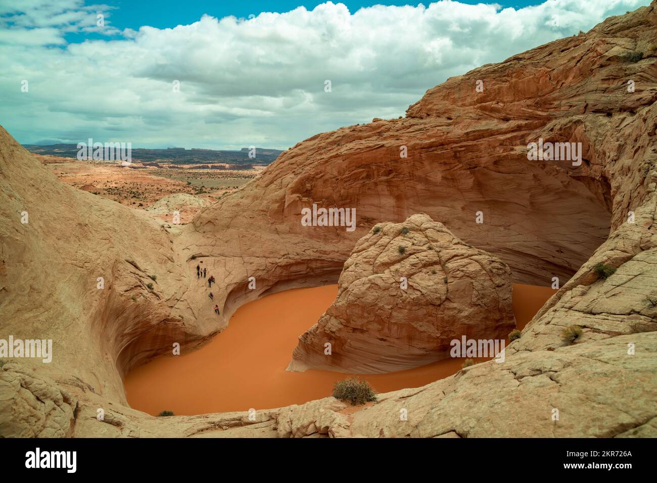 Hikers visit a unique sandstone geological feature known as the 'Cosmic ...
