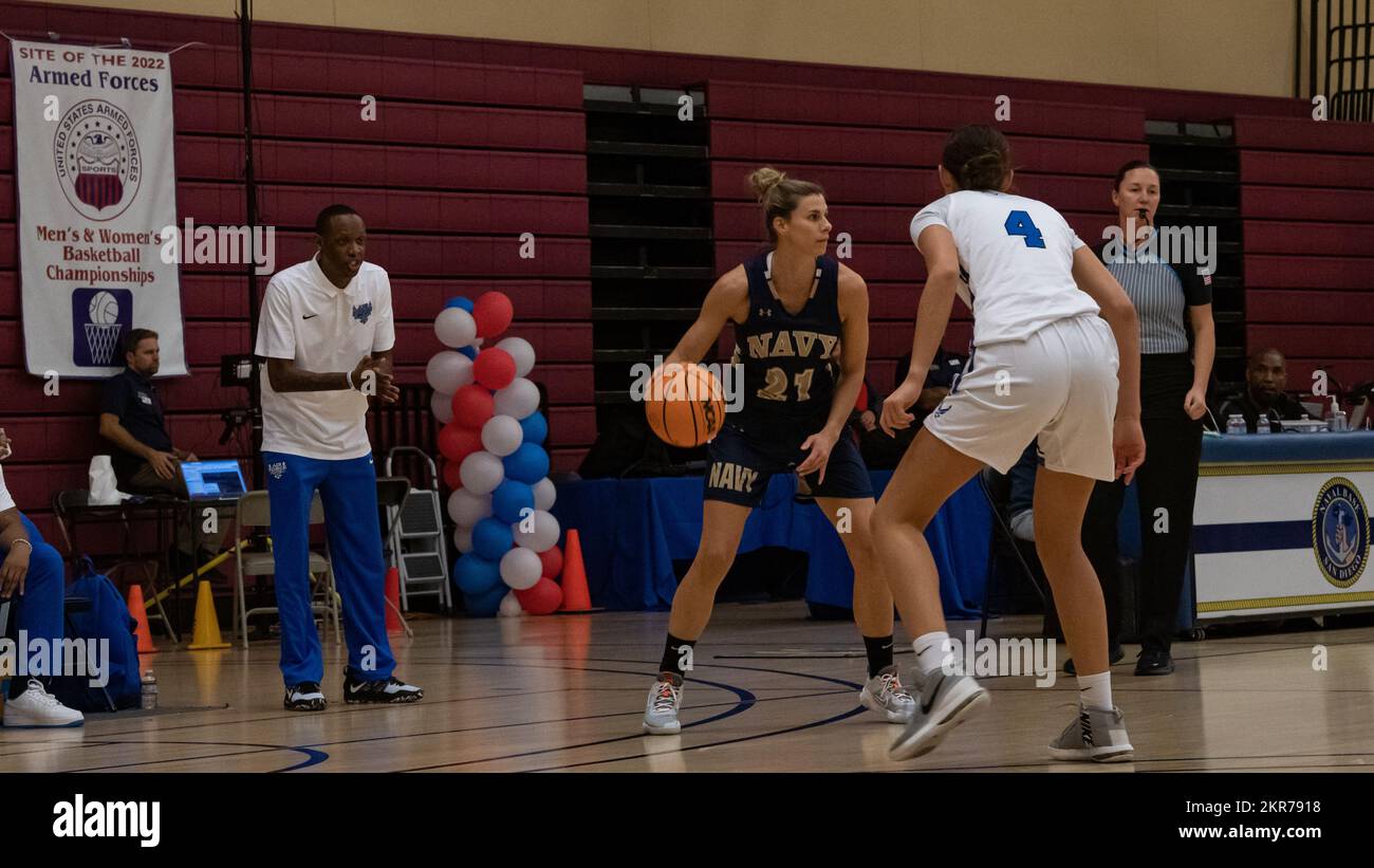 U.S. Navy Lt. Cmdr. Whitney Buffin, a member of team Navy, dribbles the ...