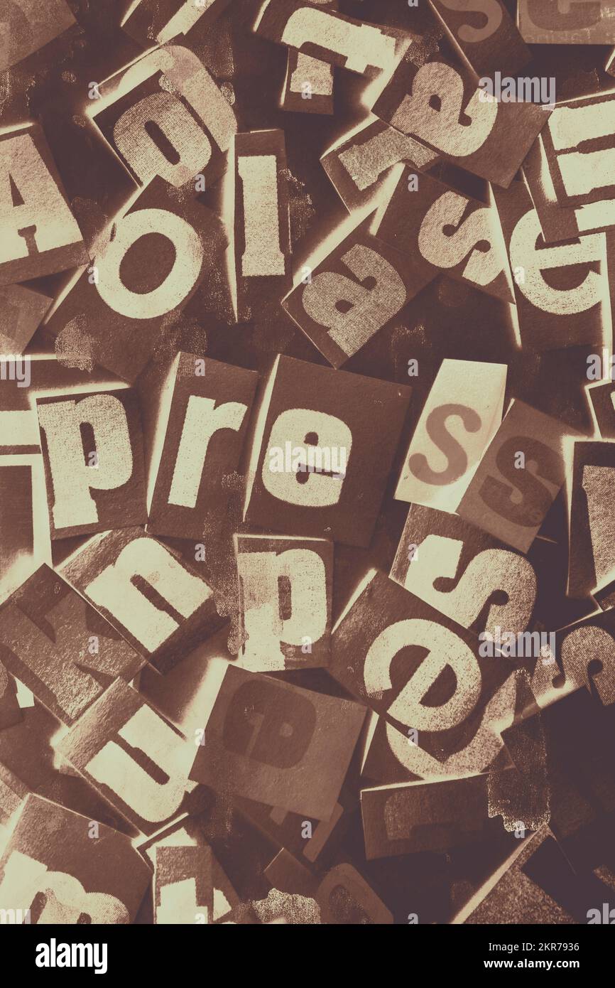 Artistic still life art on a cutting of news print letters in abstract ...