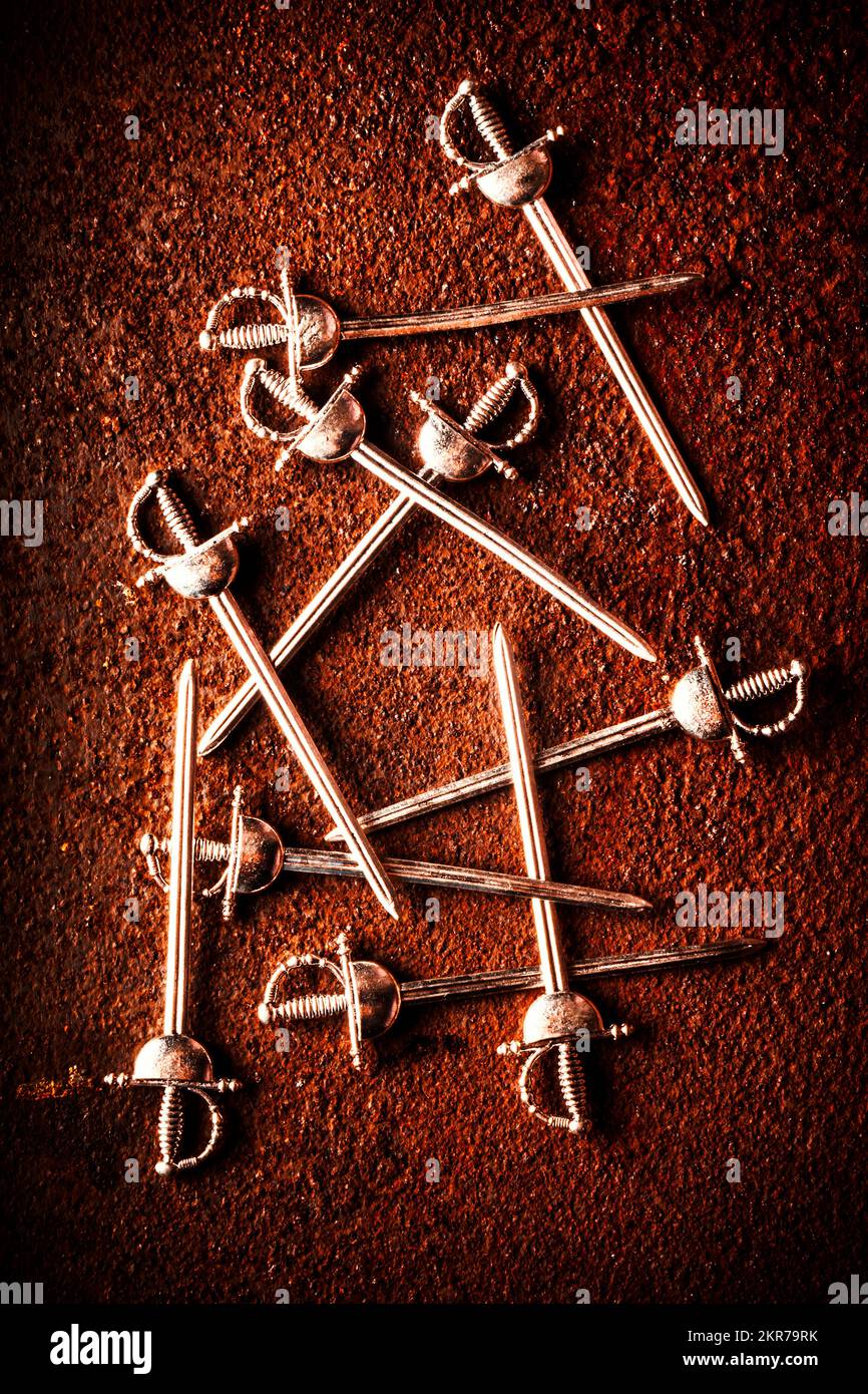 Medieval still life scene on a collective of rapier swords crossing ...