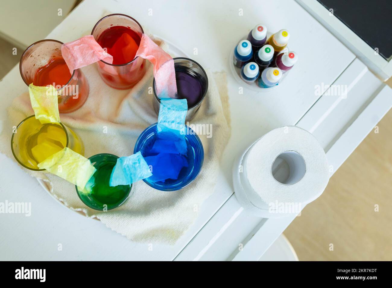 Cute baby boy learning mixing different colors with water and paint in ...