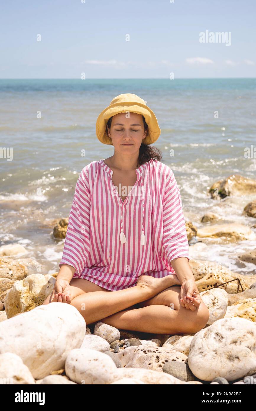 Happy relaxed woman meditation in lotus position practicing yoga ...