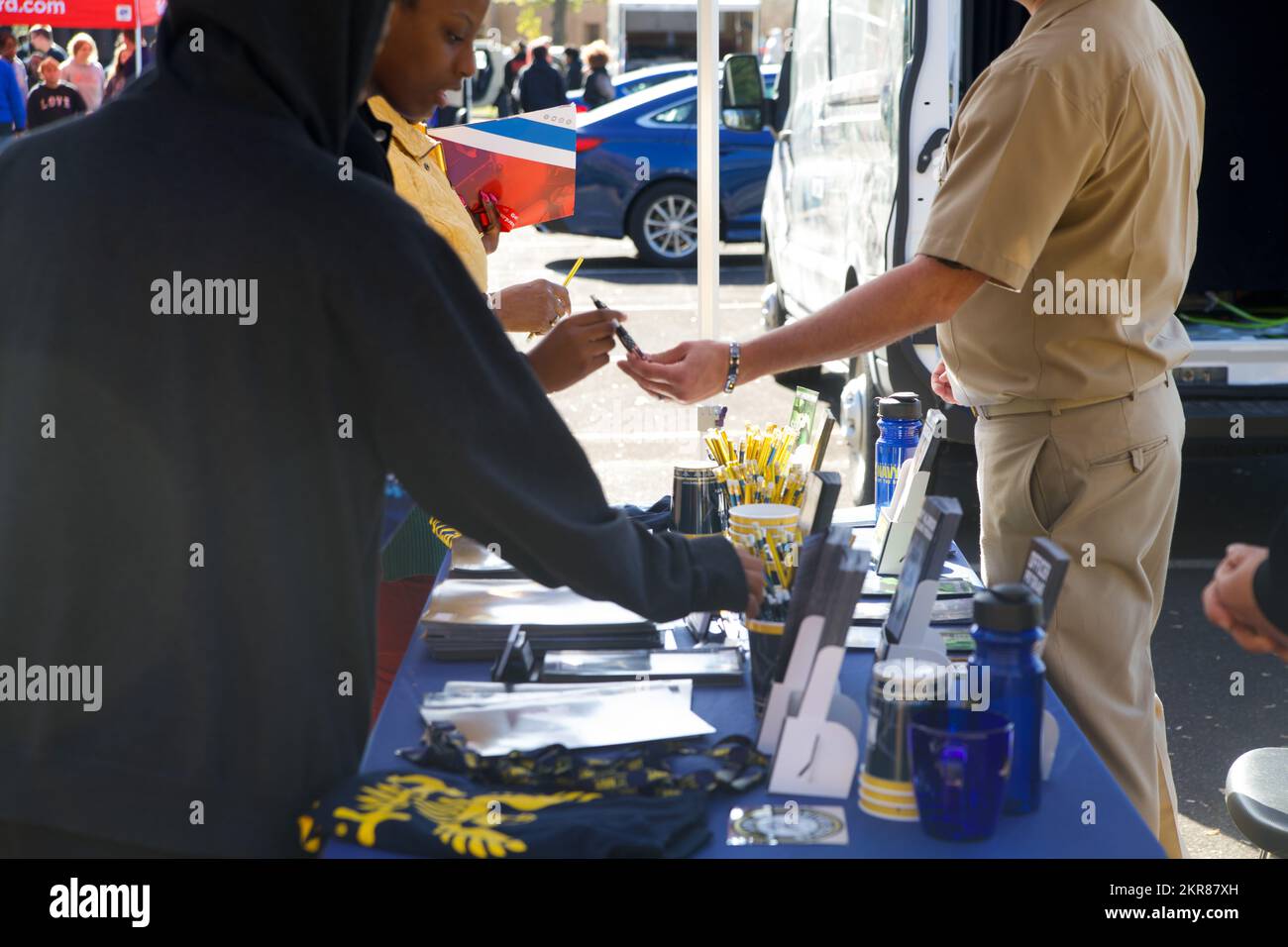 ENC Daniels passing out Navy Swag at the Navy Tent at Halifax Community ...