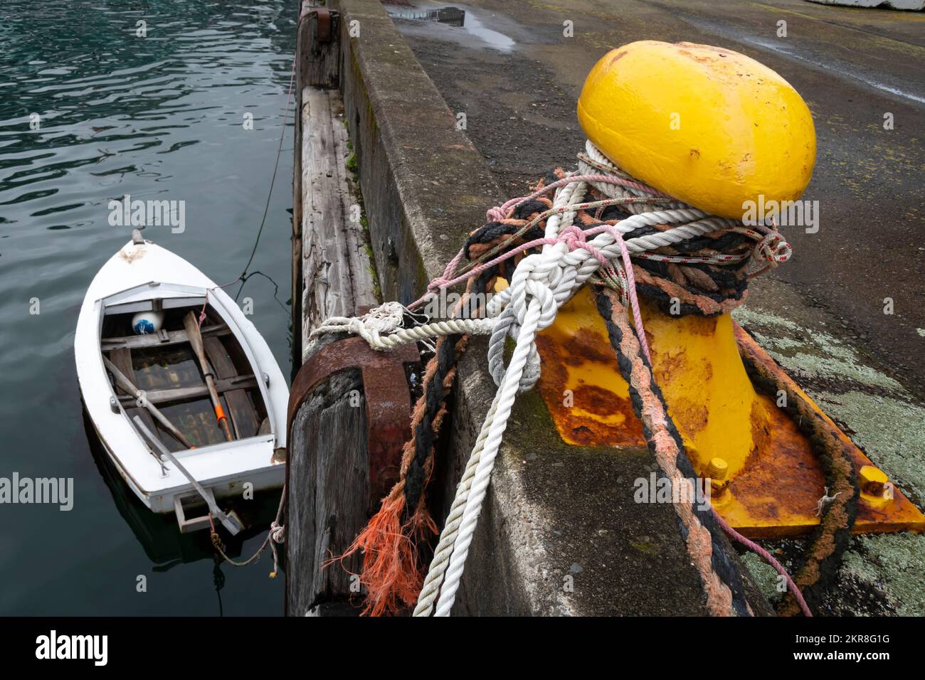 Mooring ropes tied around yellow bollard on waterfront, Wellington ...