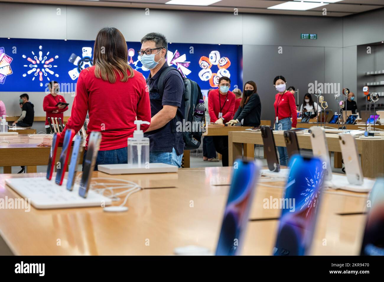 Apple employees and customers are seen at the American multinational ...