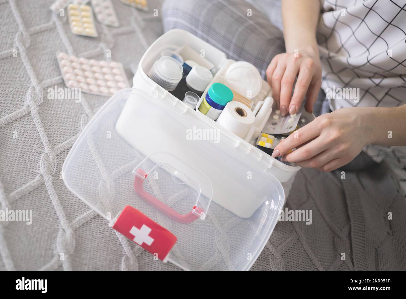 Closeup female hand placing medicament domestic first aid kit. Storage ...