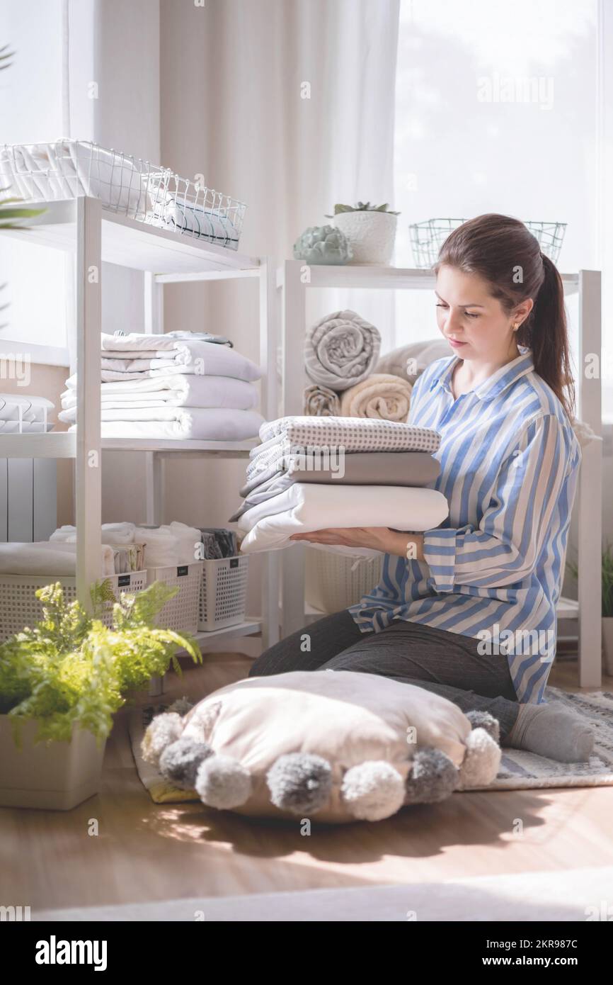 Smiling female in pajamas enjoying homework bedroom minimalist cupboard ...
