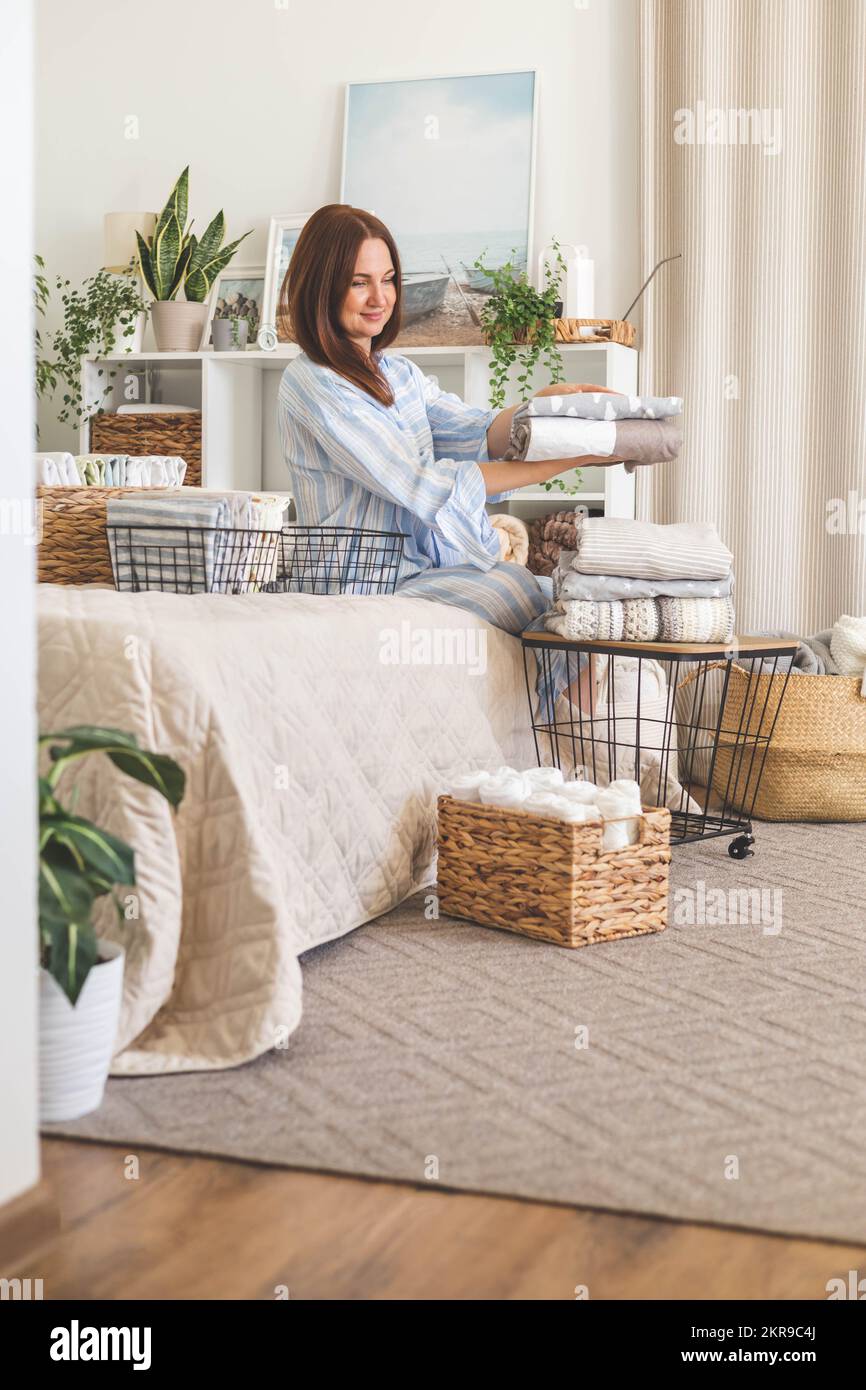 Smiling female in stylish linen dress enjoying homework bedroom ...