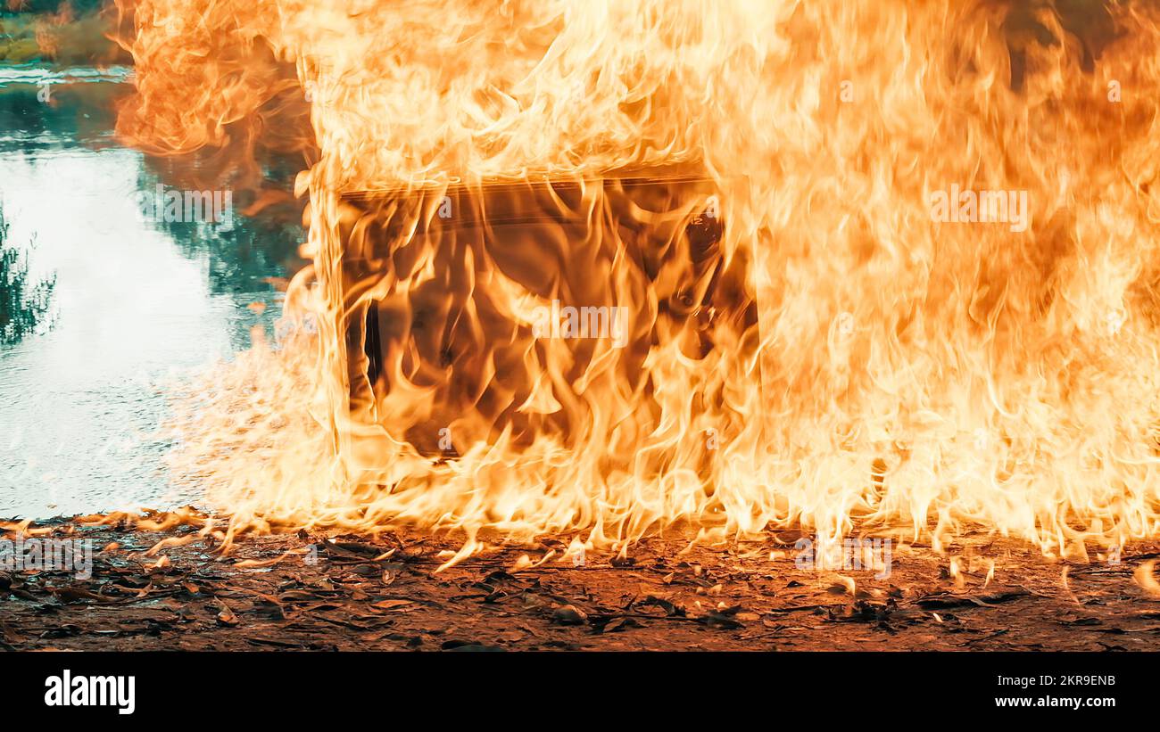 Old retro TV flares up and burns with fire next to the river Stock ...