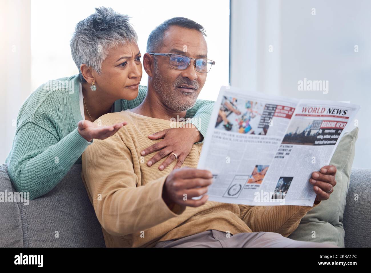 Senior couple, shocked and surprised by news while reading newspaper on ...