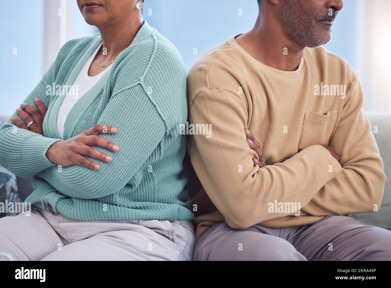 Mature Couple Arms Crossed Or Divorce Fight On Sofa In House Or Home