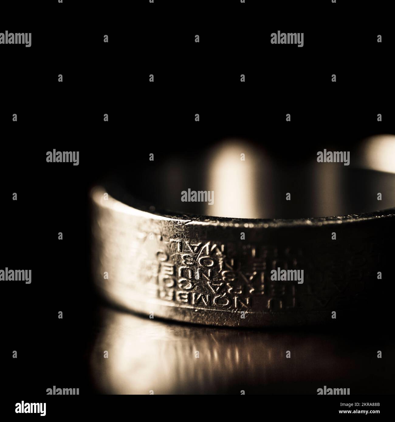 Worn and weathered mens silver ring lay abandoned on a reflective ...